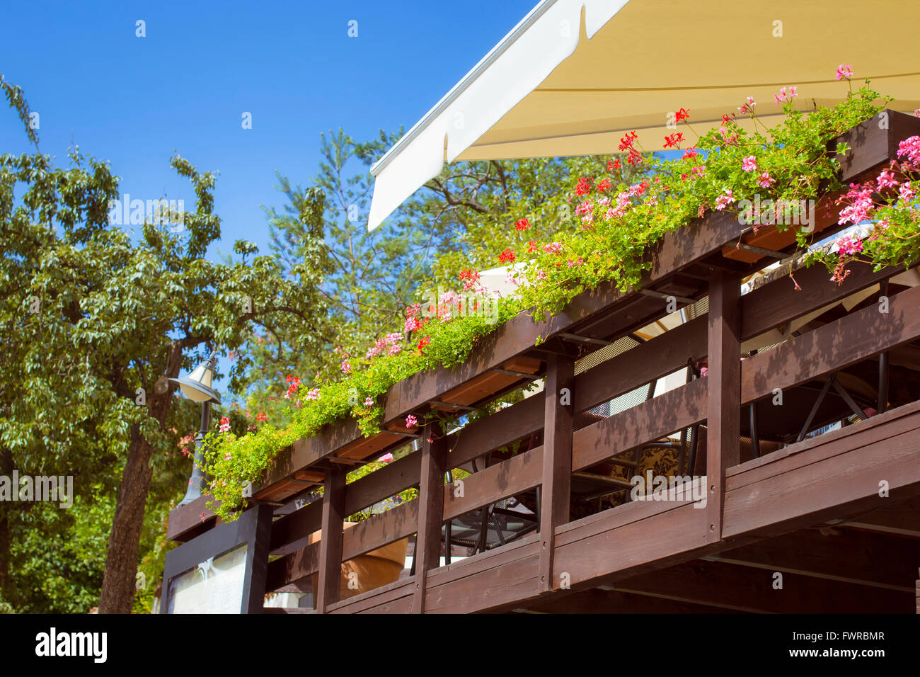 Veranda of the restaurant with flower beds under a canopy near the ...