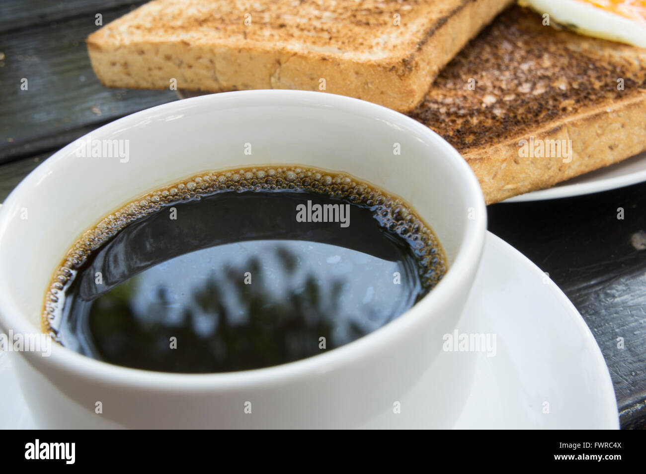 coffee and toast on the wooden table Stock Photo - Alamy