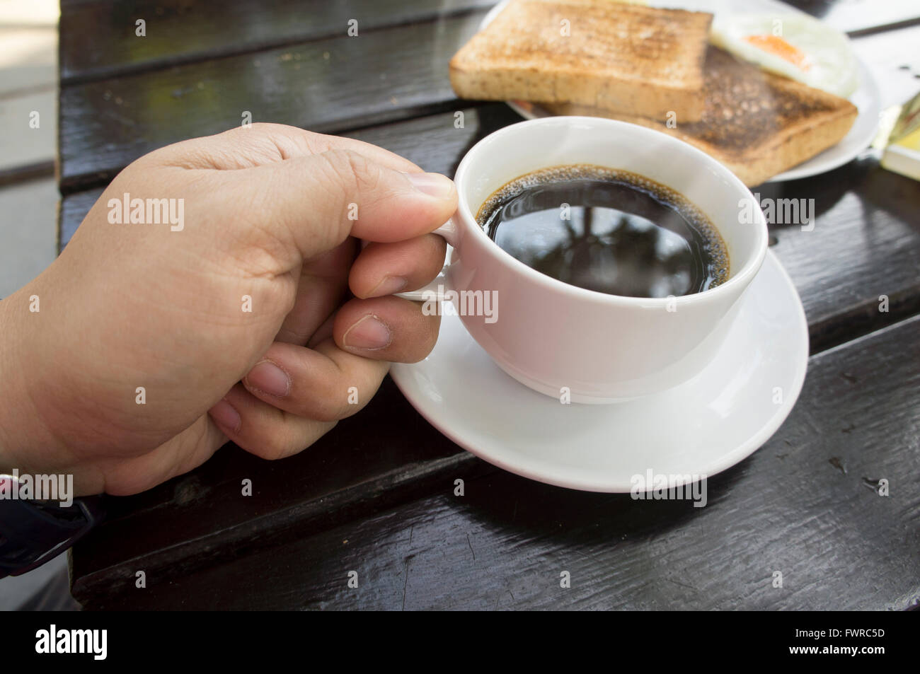 man hand lift coffee cup morning Stock Photo - Alamy