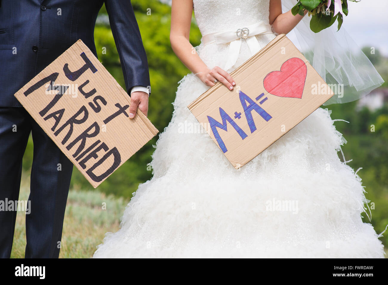 bride and groom with just a married signs Stock Photo - Alamy