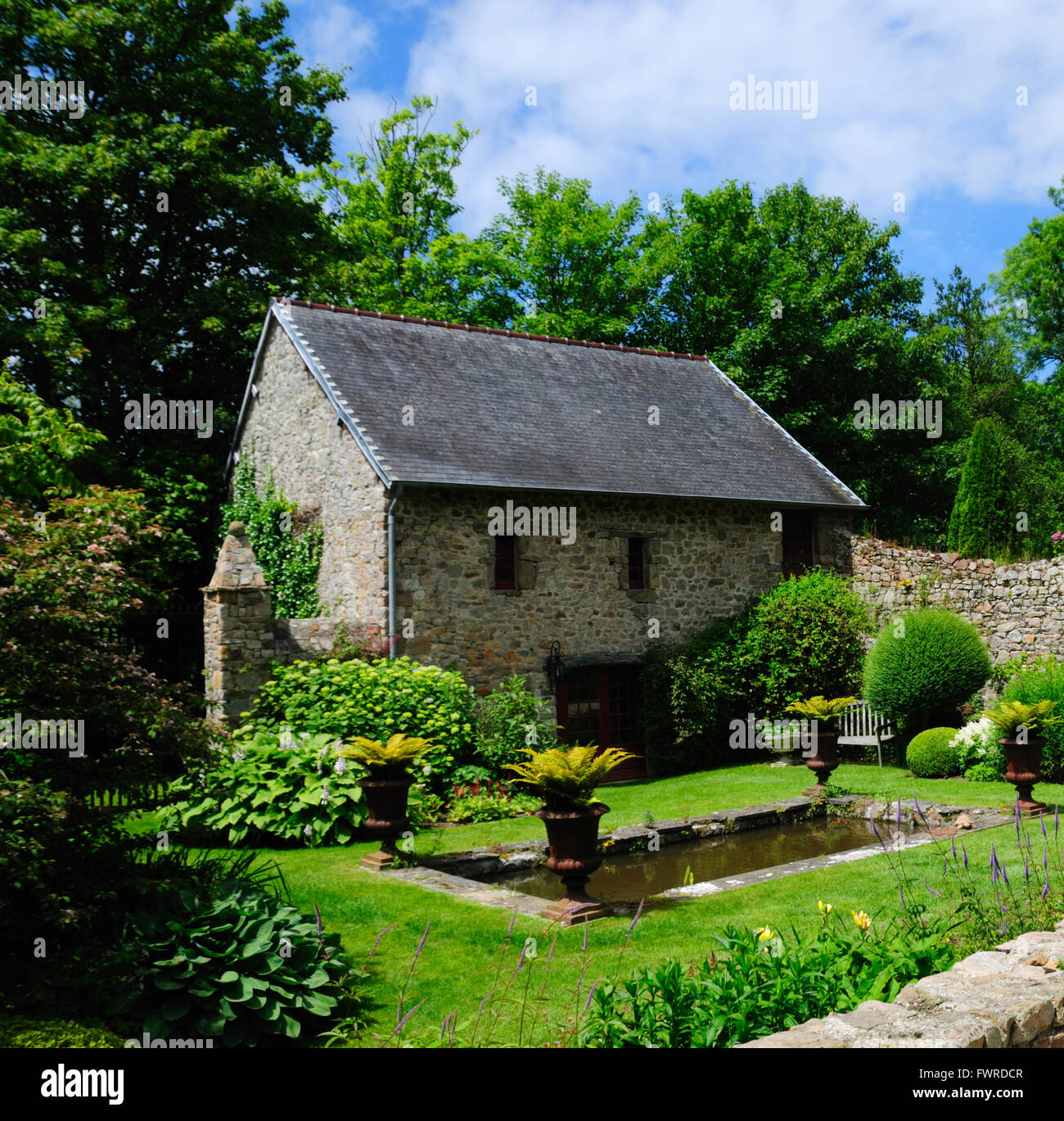 Old Stone cottage and fish pond in an ornamental garden Stock Photo - Alamy