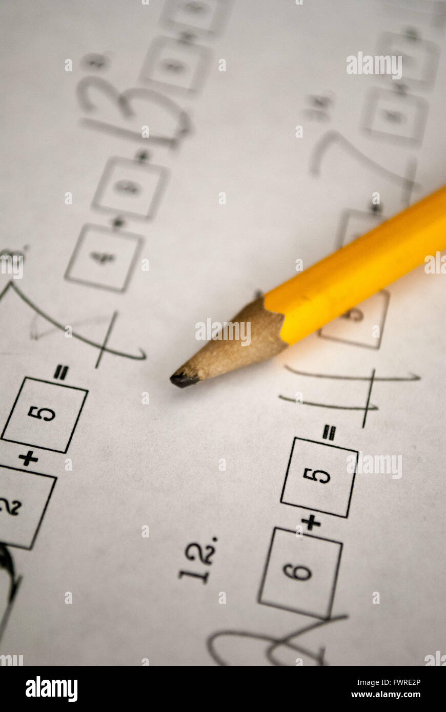 Pencil laying on top of math homework Stock Photo - Alamy