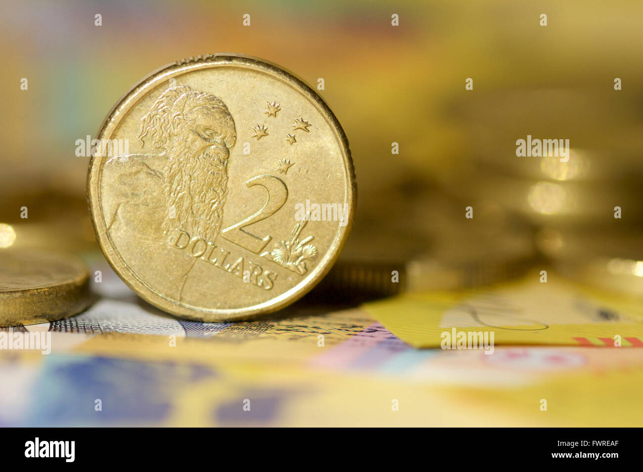 An Australian two dollar coin against a background of Australian notes ...