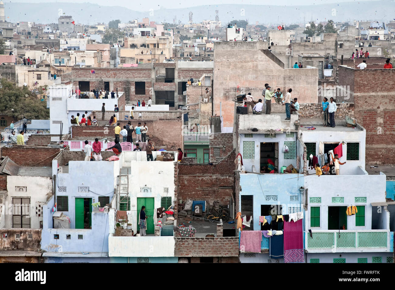 Indian people flying kites from the rooftops. Kite Day Festival. Jaipur ...