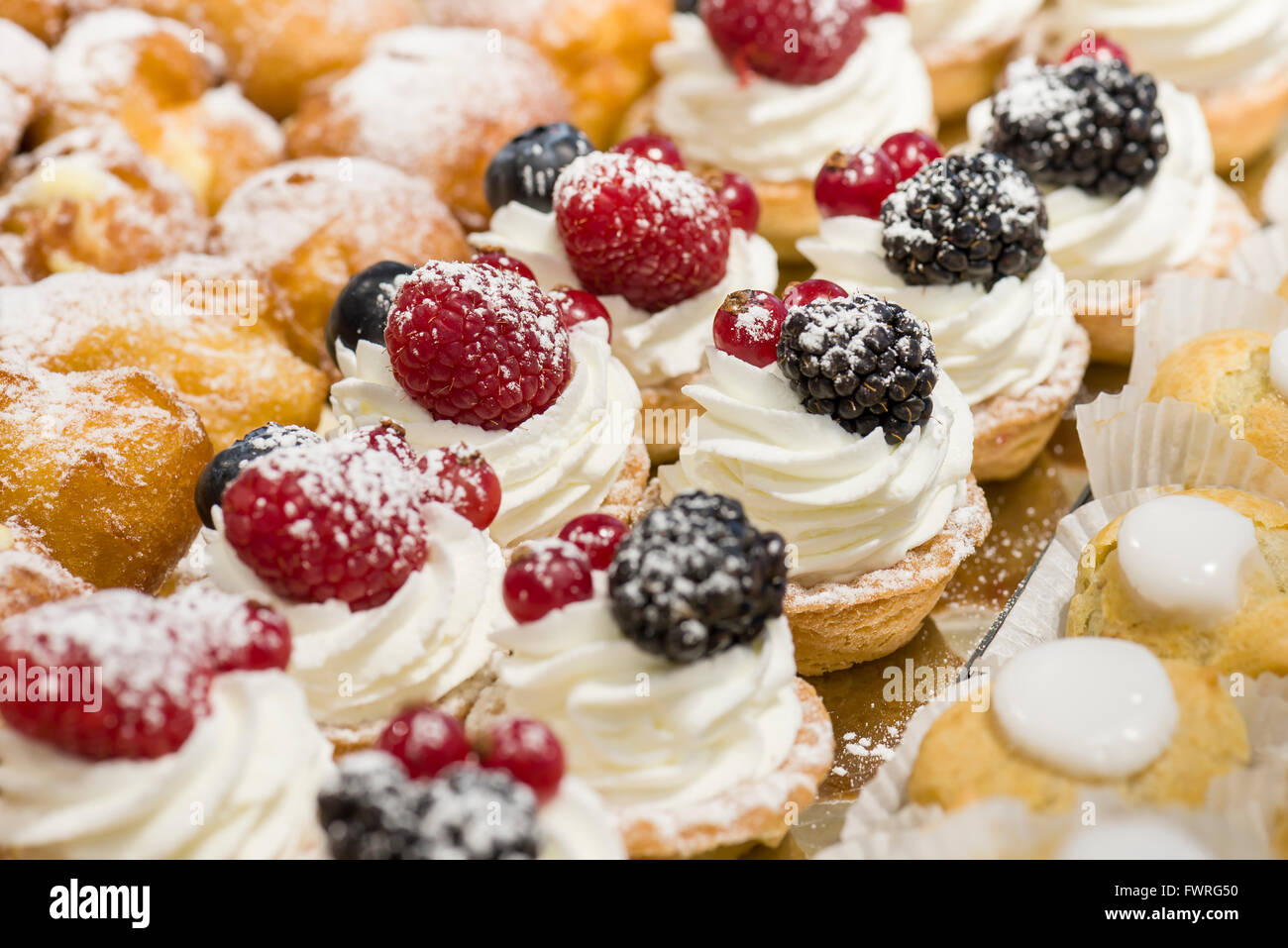 pastries with fresh cream decorated with fruits Stock Photo - Alamy