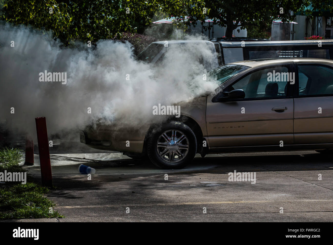 Car fire in parking lot of service station, fast food market Stock ...
