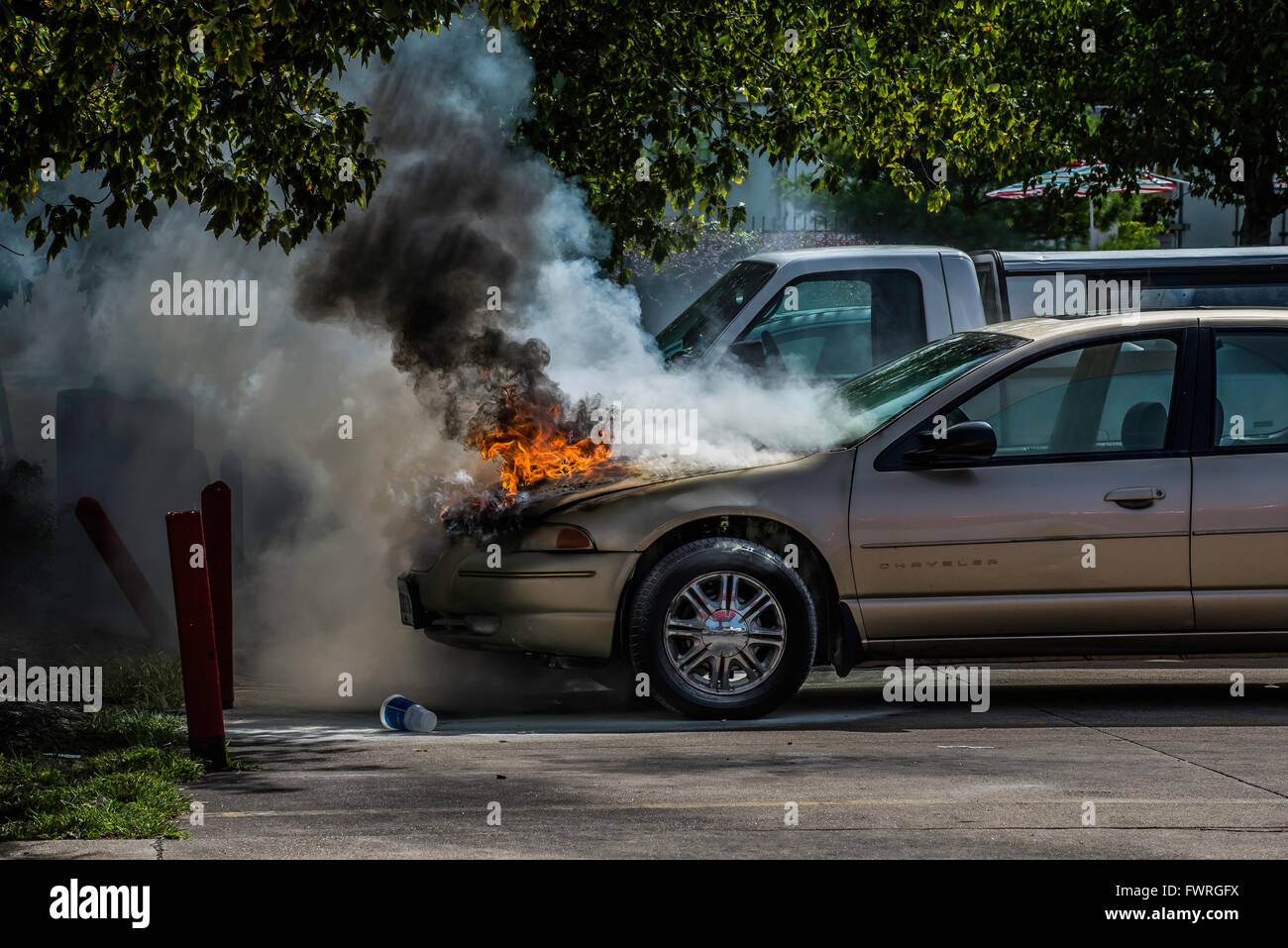 Car fire in parking lot of service station, fast food market Stock ...