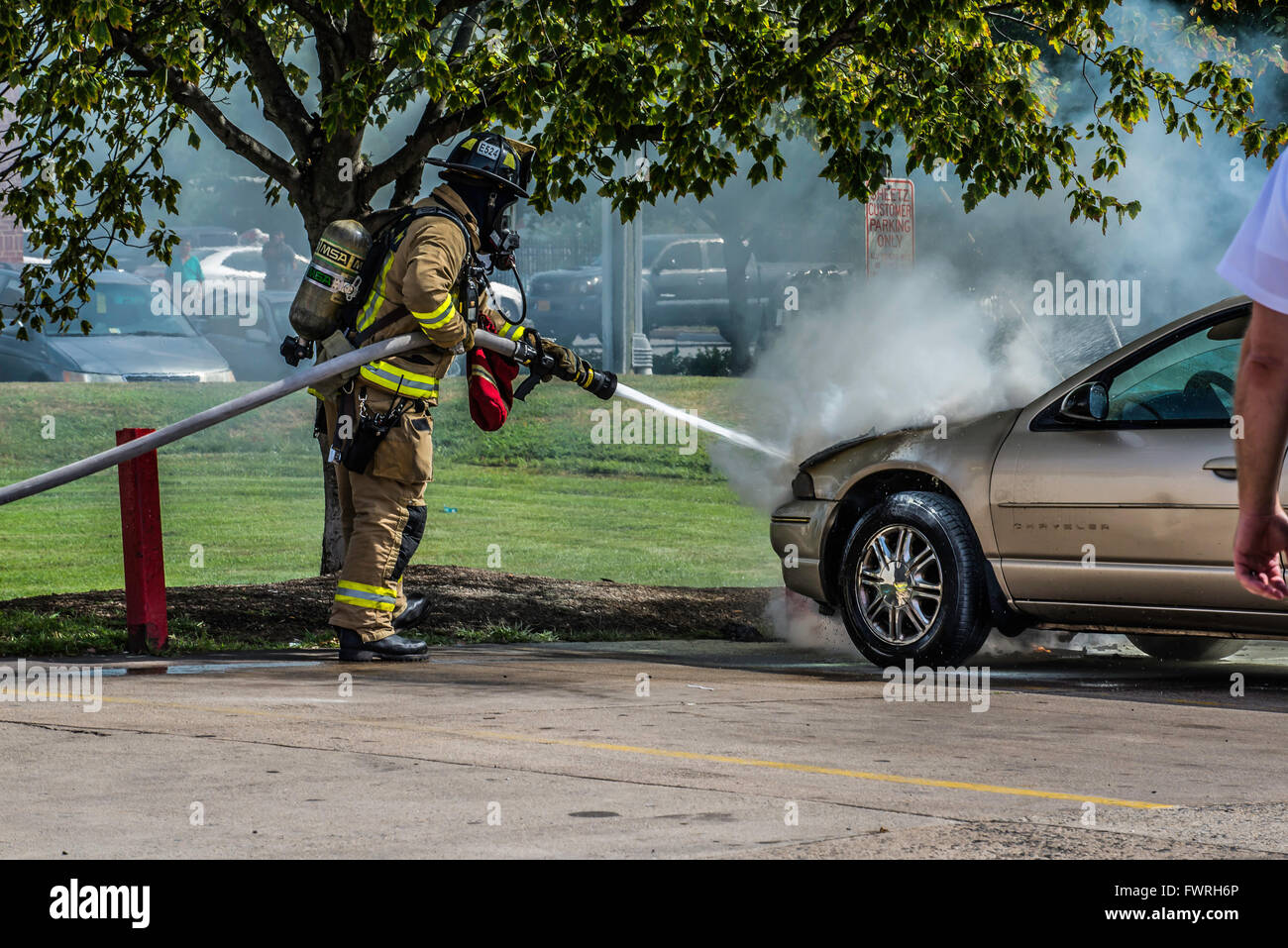 Car fire in parking lot of service station, fast food market Stock ...