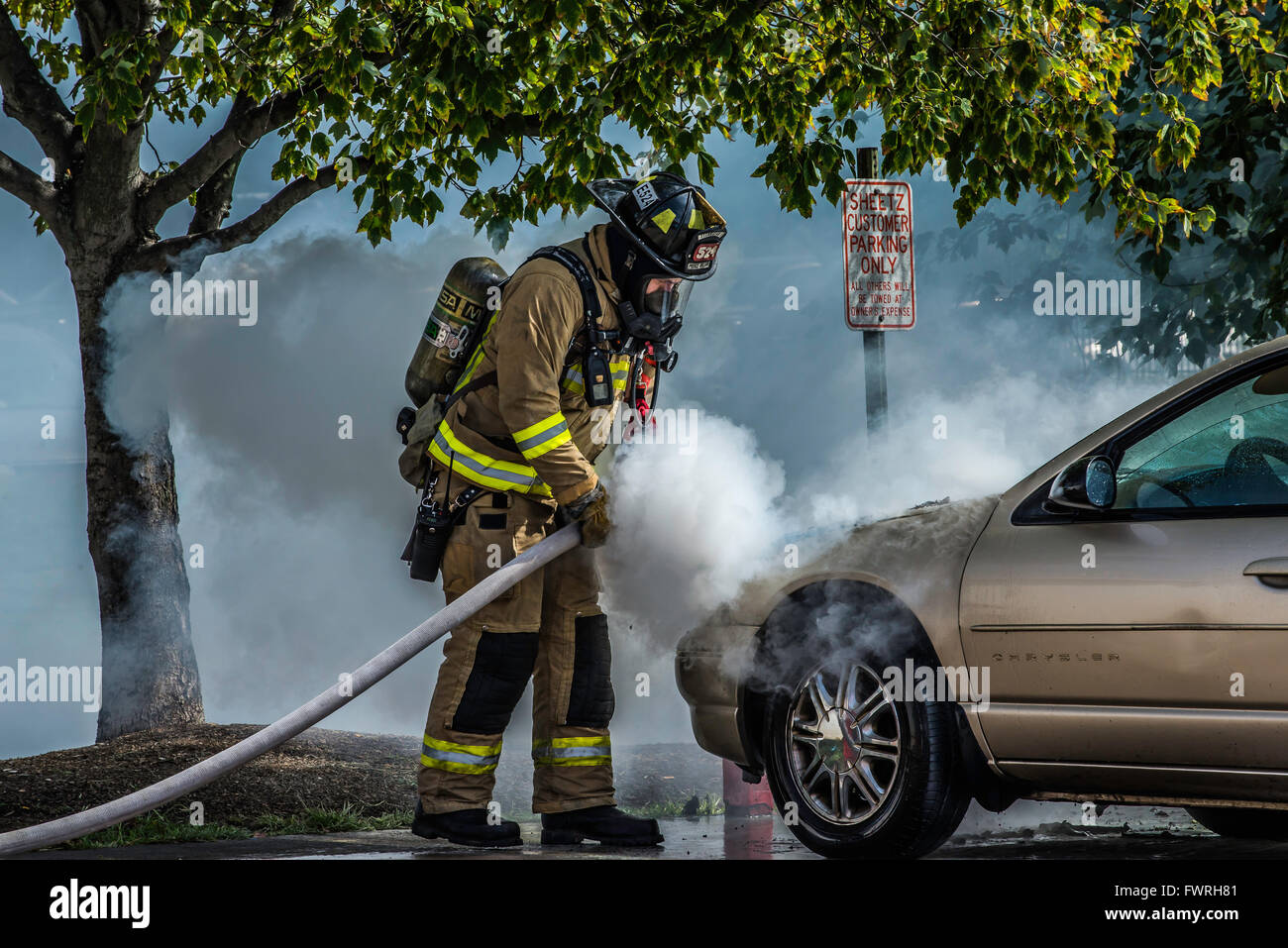 Car fire in parking lot of service station, fast food market Stock ...