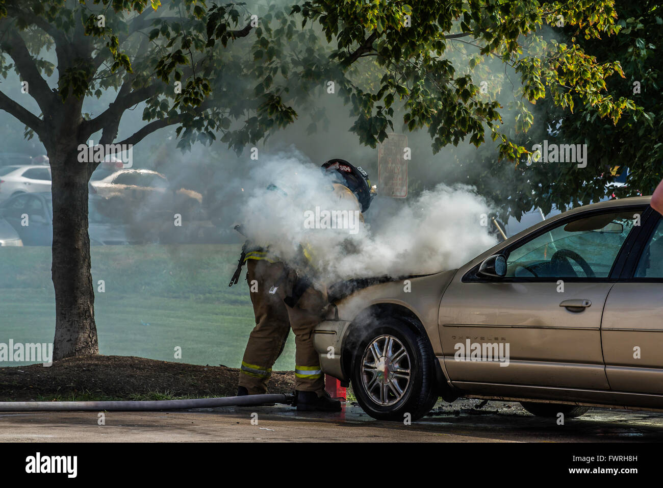Car fire in parking lot of service station, fast food market Stock ...