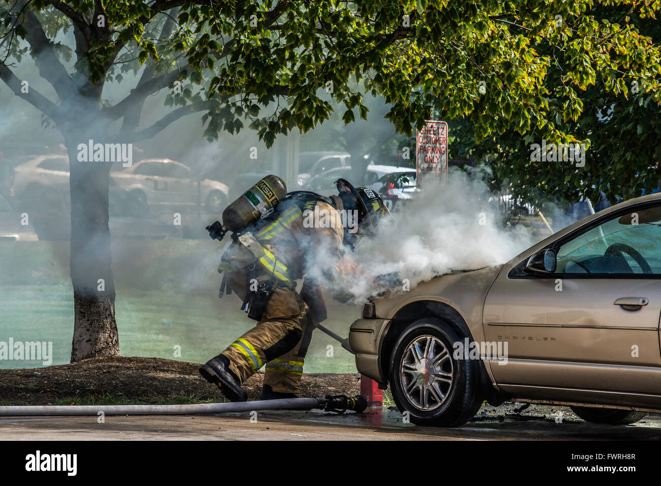 Car fire in parking lot of service station, fast food market Stock ...