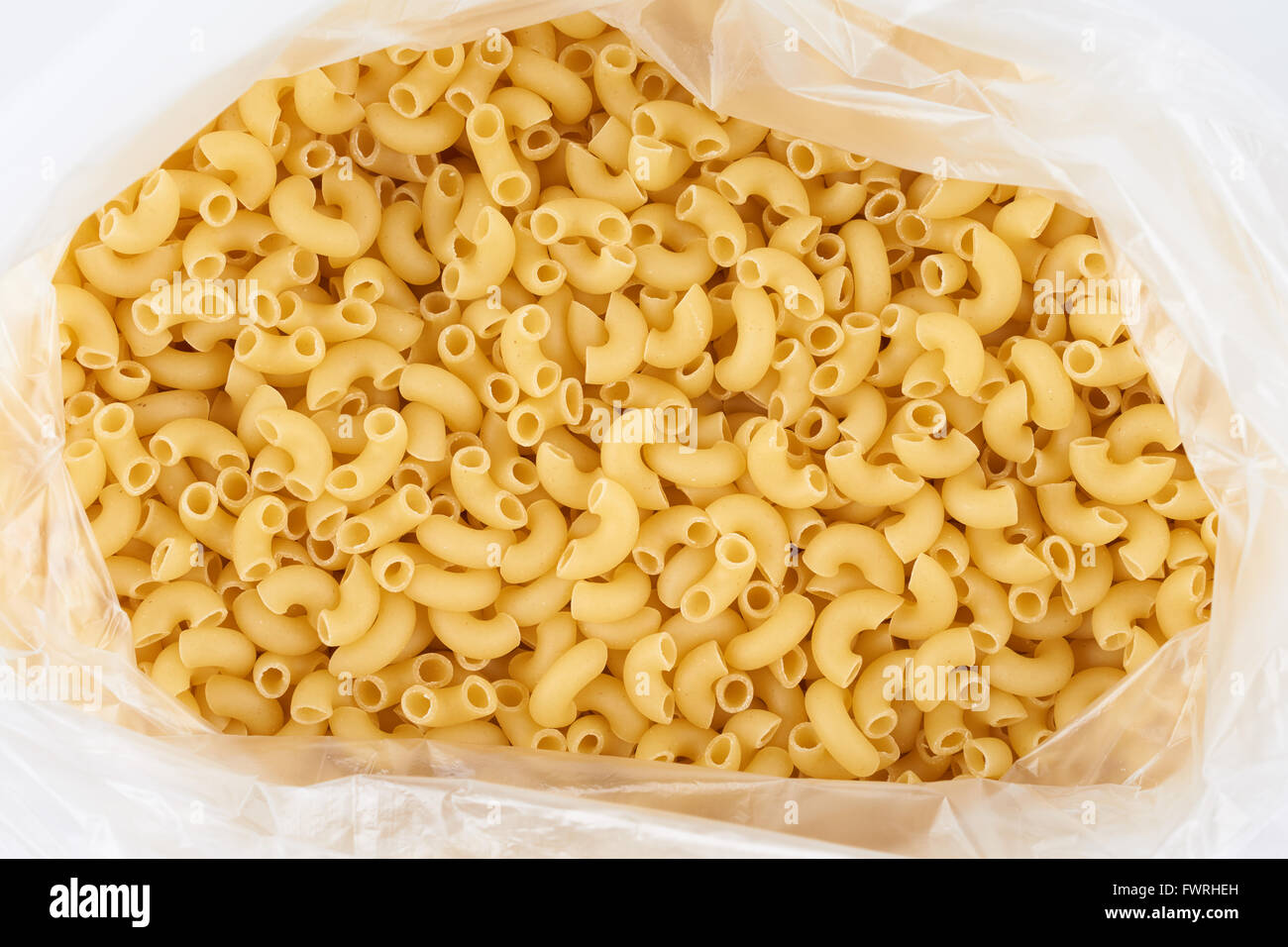 Pasta in open plastic pack isolated on white. Upper view Stock Photo ...