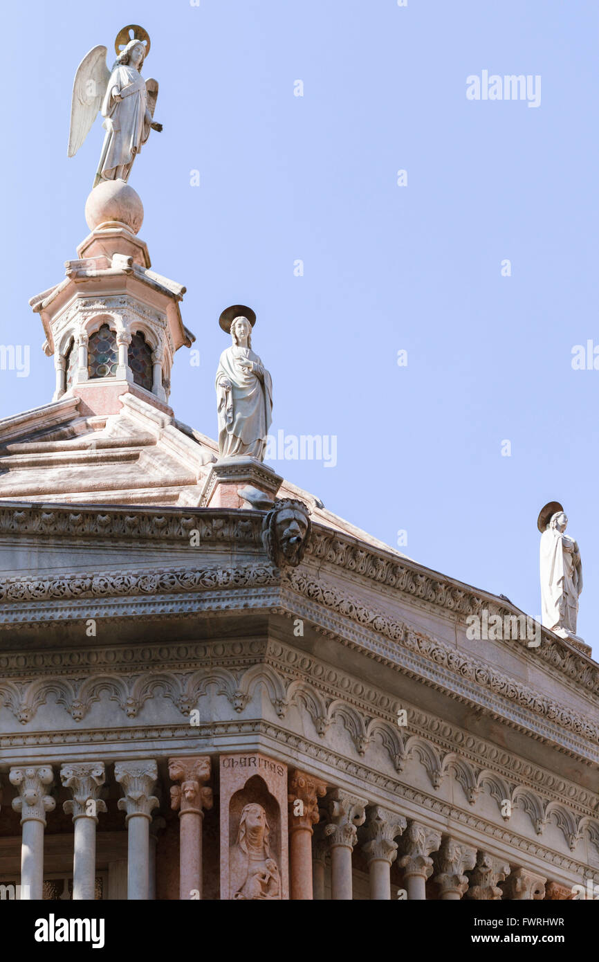 Angel and statues of the Virtues on the medieval baptistery of Bergamo ...