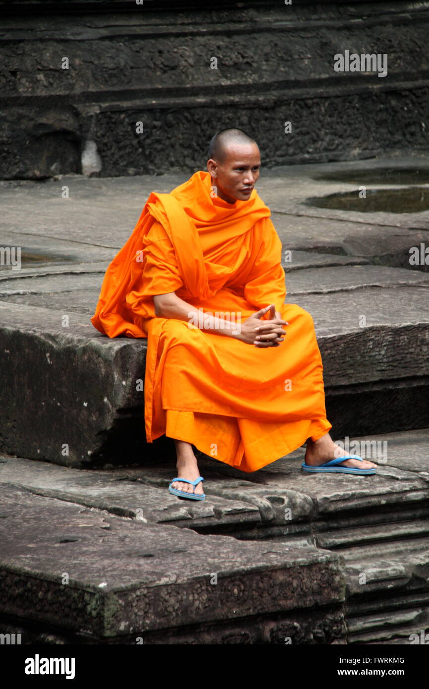A monk contemplating life in the middle of Angkor Wat, Cambodia Stock ...