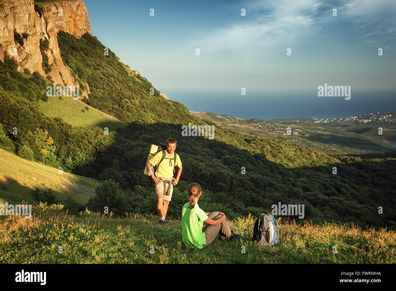 Couple is walking a mountain valley and looking at each other Stock ...