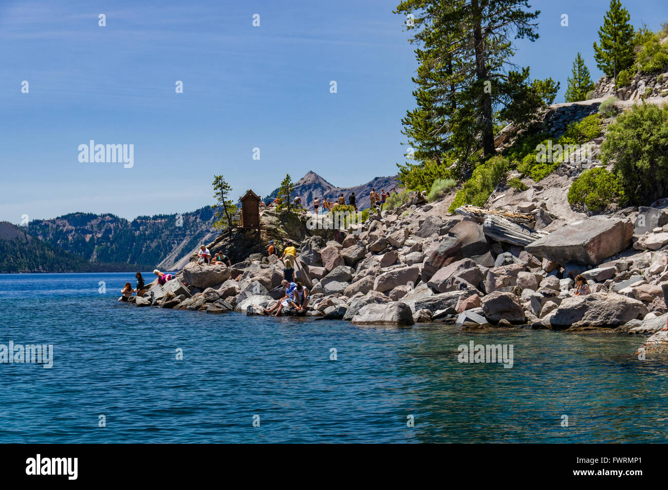 Tourists swimming in the crystal clear water of Crater Lake. Crater ...