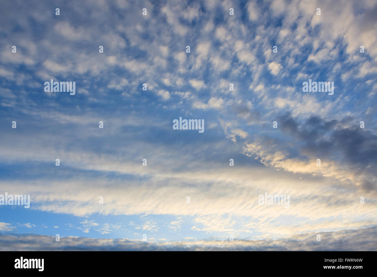 Calm sunset clouds and blue sky Stock Photo - Alamy