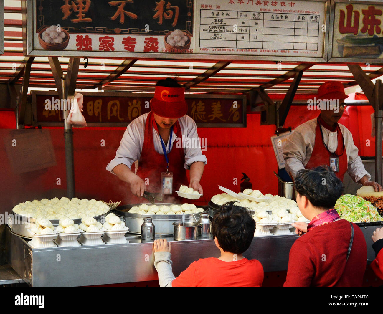 A vendor selling steamed dumplings and Chinese buns in Wang Fu Jing ...