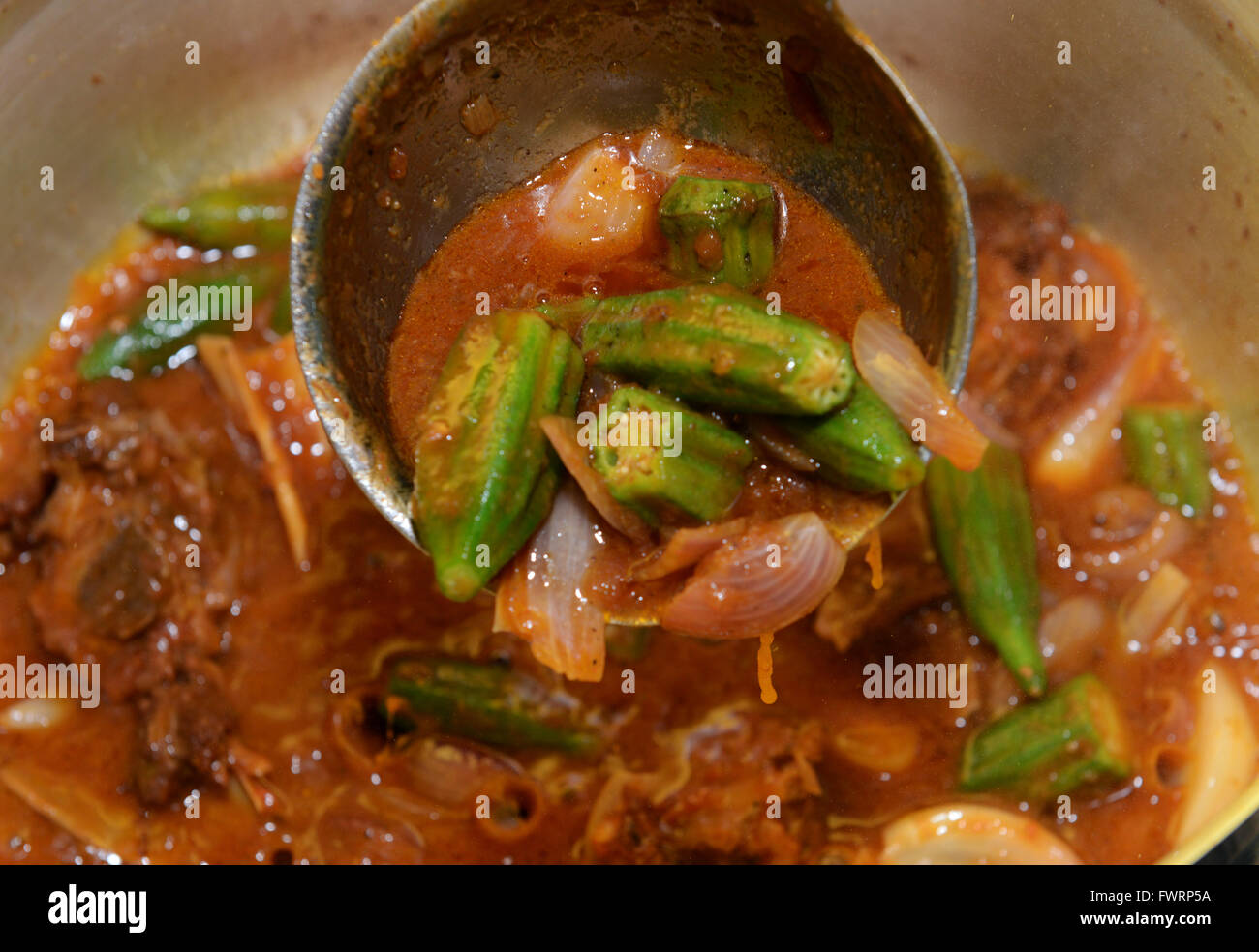 Cooking A famous Sudanese Okra dish called Bamia Bell Kisra Stock Photo ...