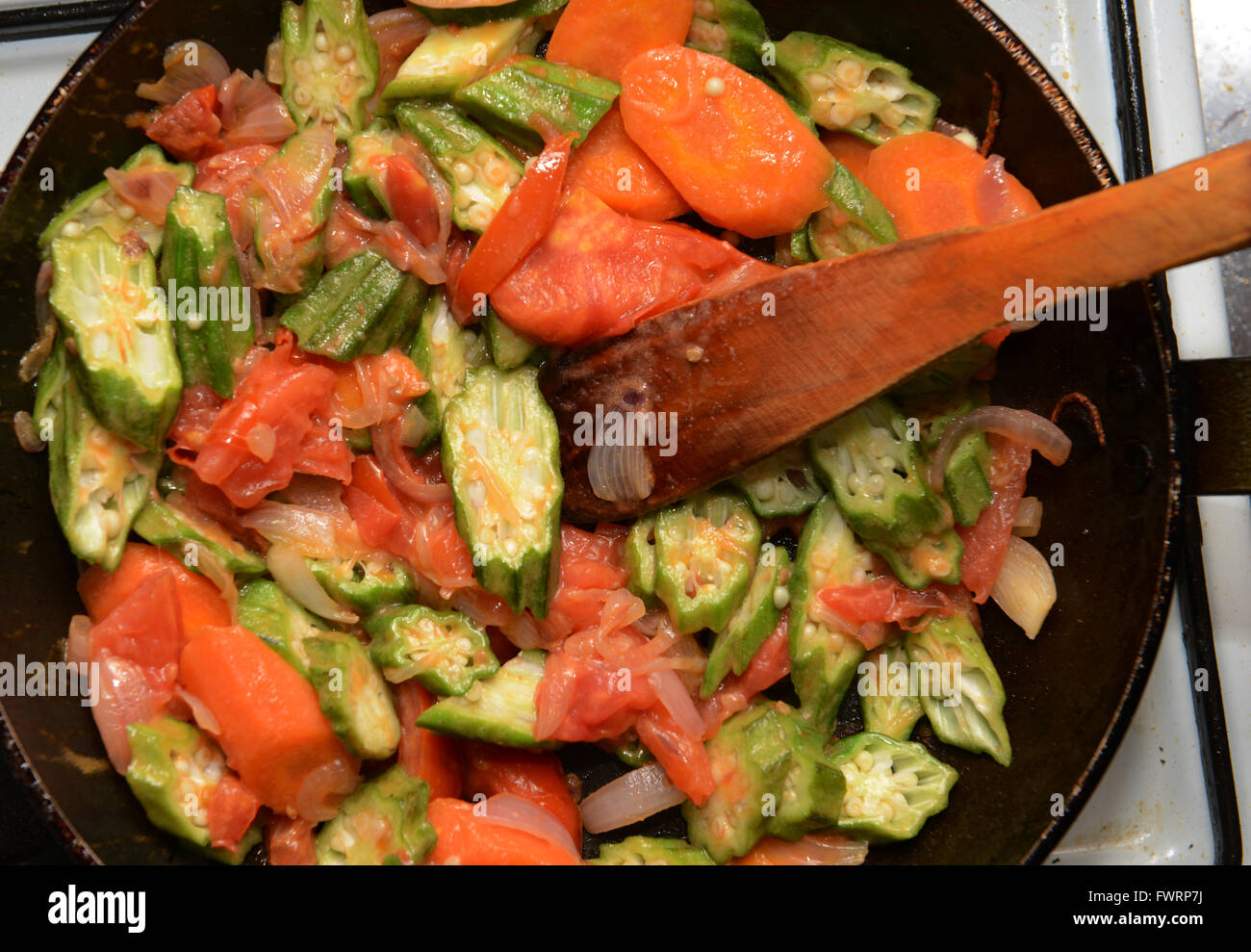Ethiopian chefs cutting and cooking a stir fry Okra dish in the Wudasie ...