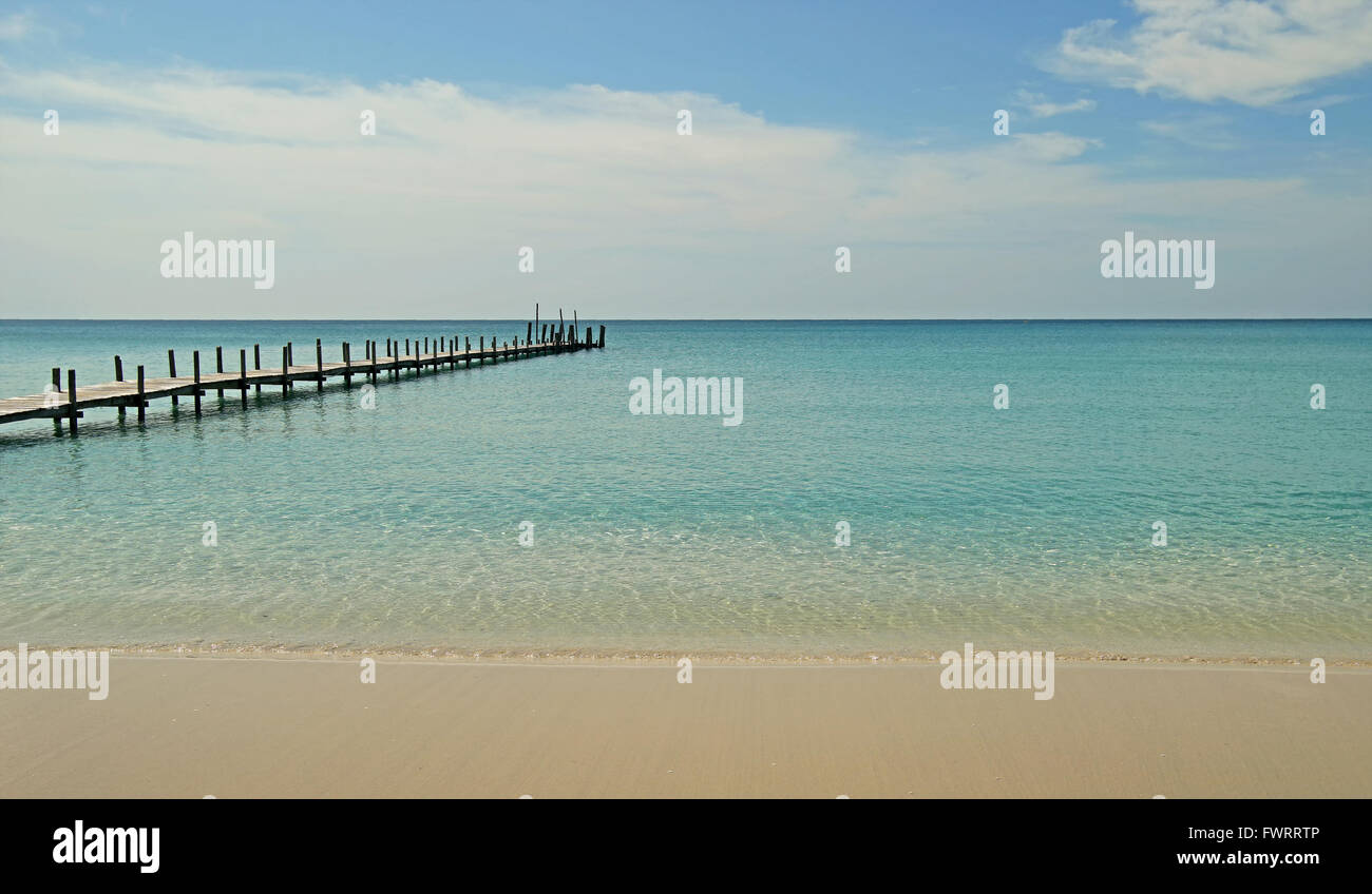 wooden jetty on sunny beach with nice sky background Stock Photo - Alamy