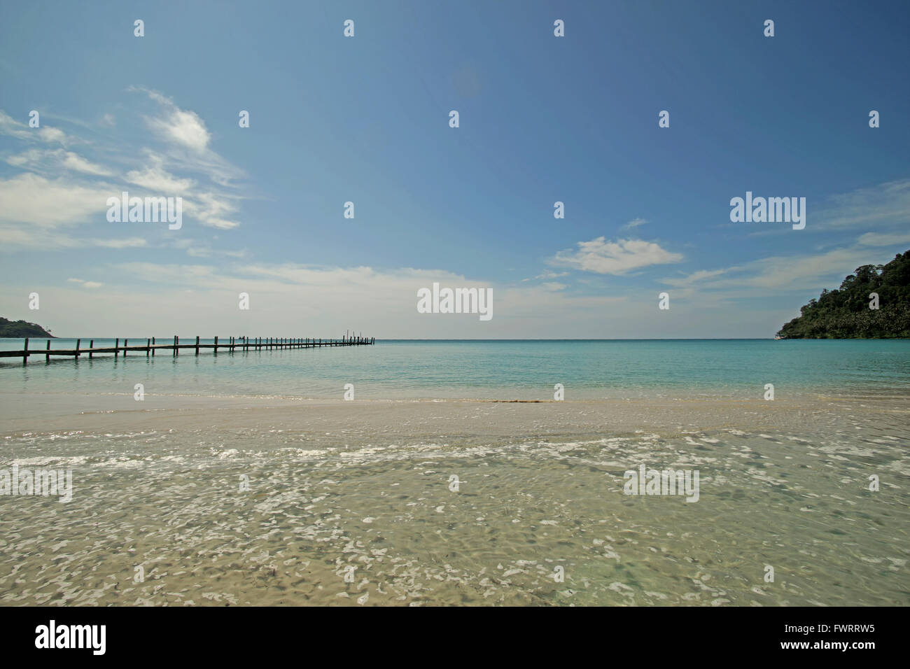 wooden jetty on sunny beach with nice sky background Stock Photo - Alamy