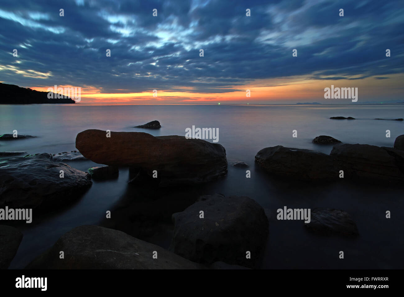 Rocks in sea shore calm hi-res stock photography and images - Alamy