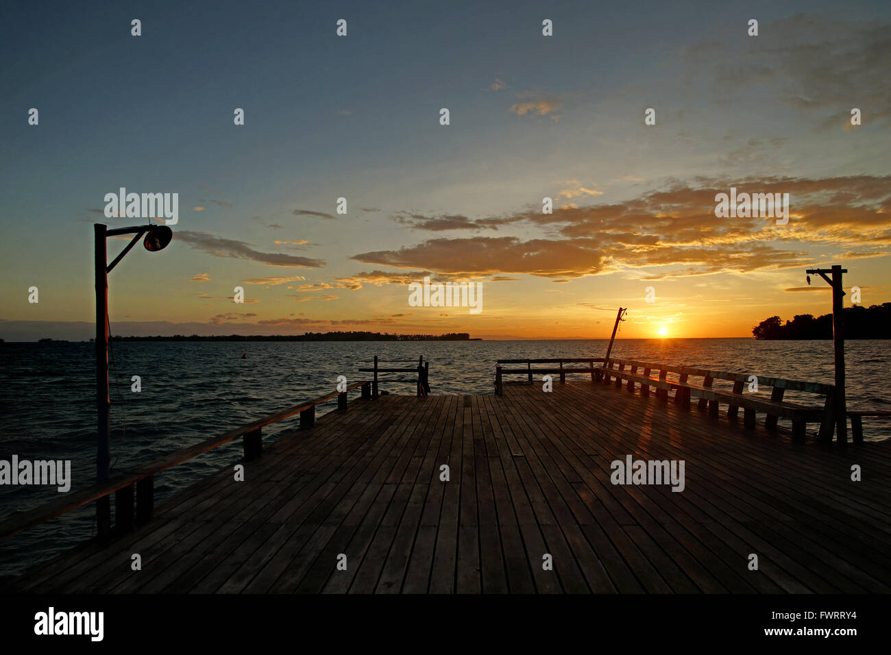 wooden jetty on beach with beautiful sunrise background Stock Photo - Alamy
