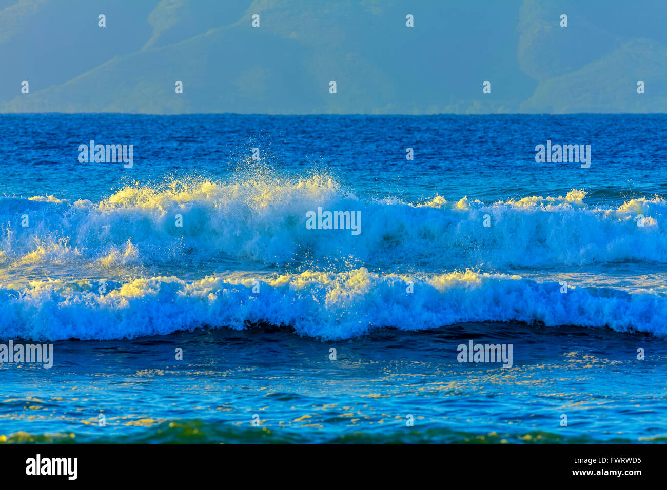 series of sunlit waves breaking Hawaii Stock Photo - Alamy