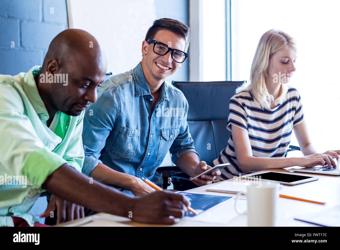 Colleagues working at their desk Stock Photo - Alamy