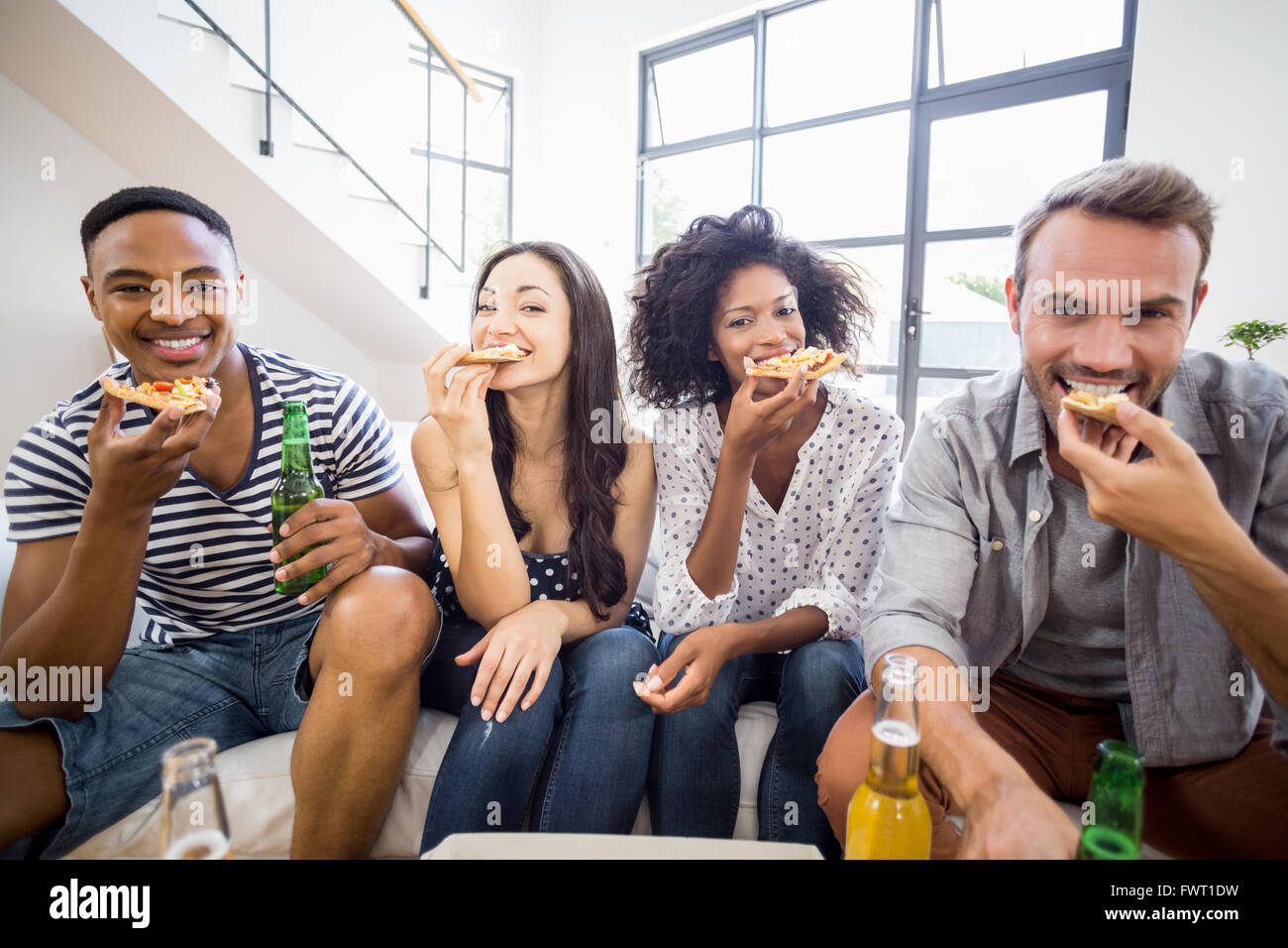 Friends having a pizza Stock Photo - Alamy