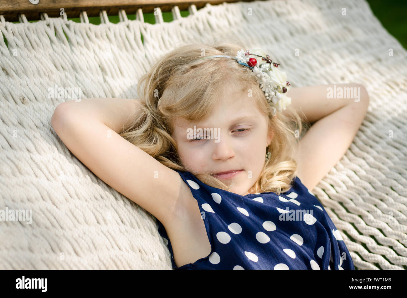 beautiful blond girl lying in white hammock Stock Photo - Alamy