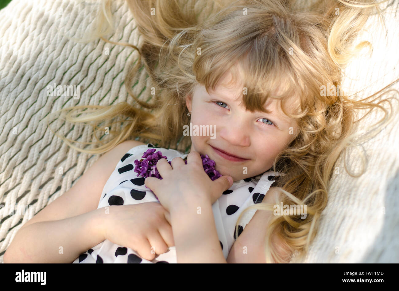beautiful smiling blond girl lying in white hammock Stock Photo - Alamy