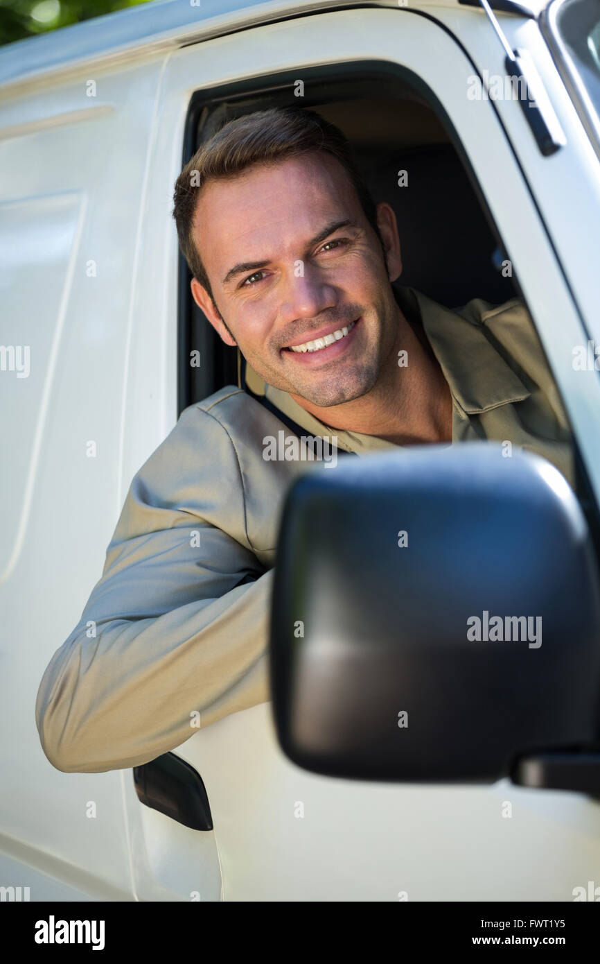 Delivery man driving in his van Stock Photo - Alamy
