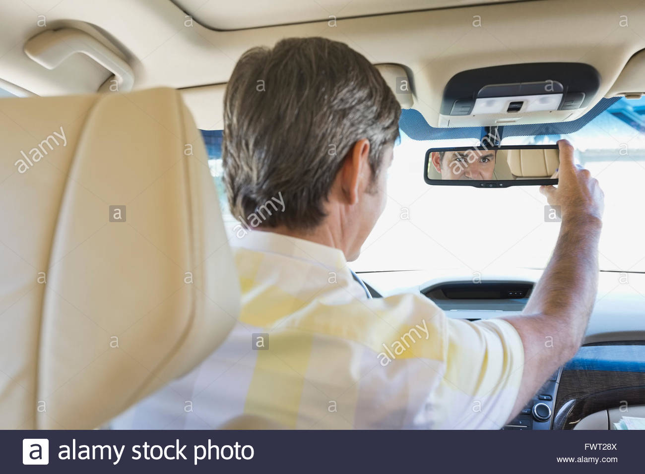 Man looking rear view mirror in car hi-res stock photography and images ...