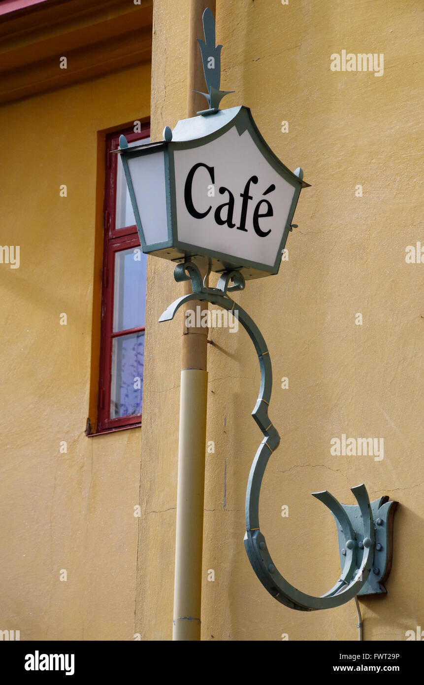 Café sign on a yellow wall Stock Photo - Alamy