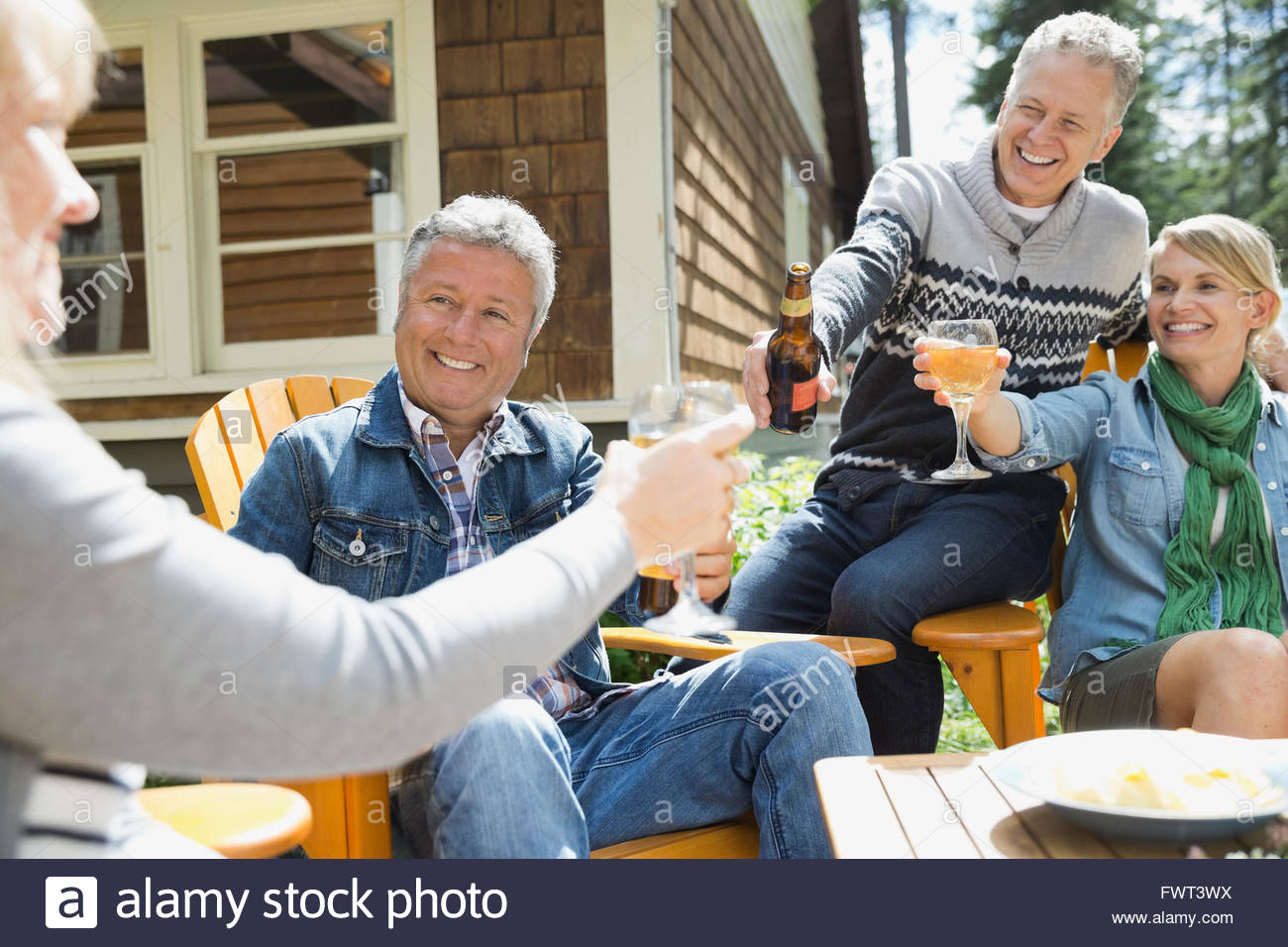 Middle-aged friends toasting outdoors Stock Photo - Alamy