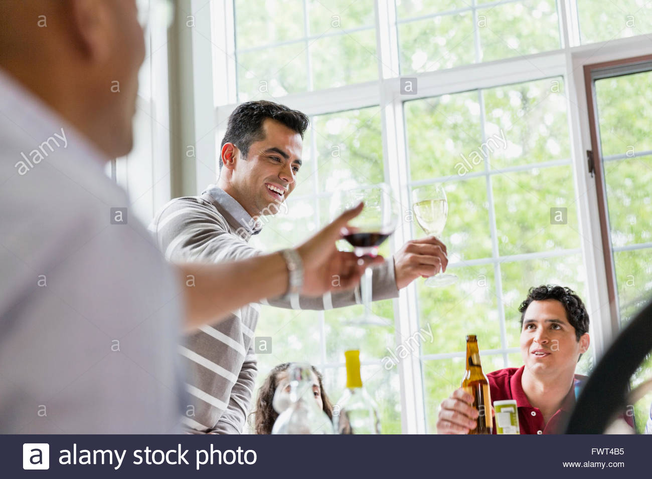 Friends toasting with drinks Stock Photo - Alamy