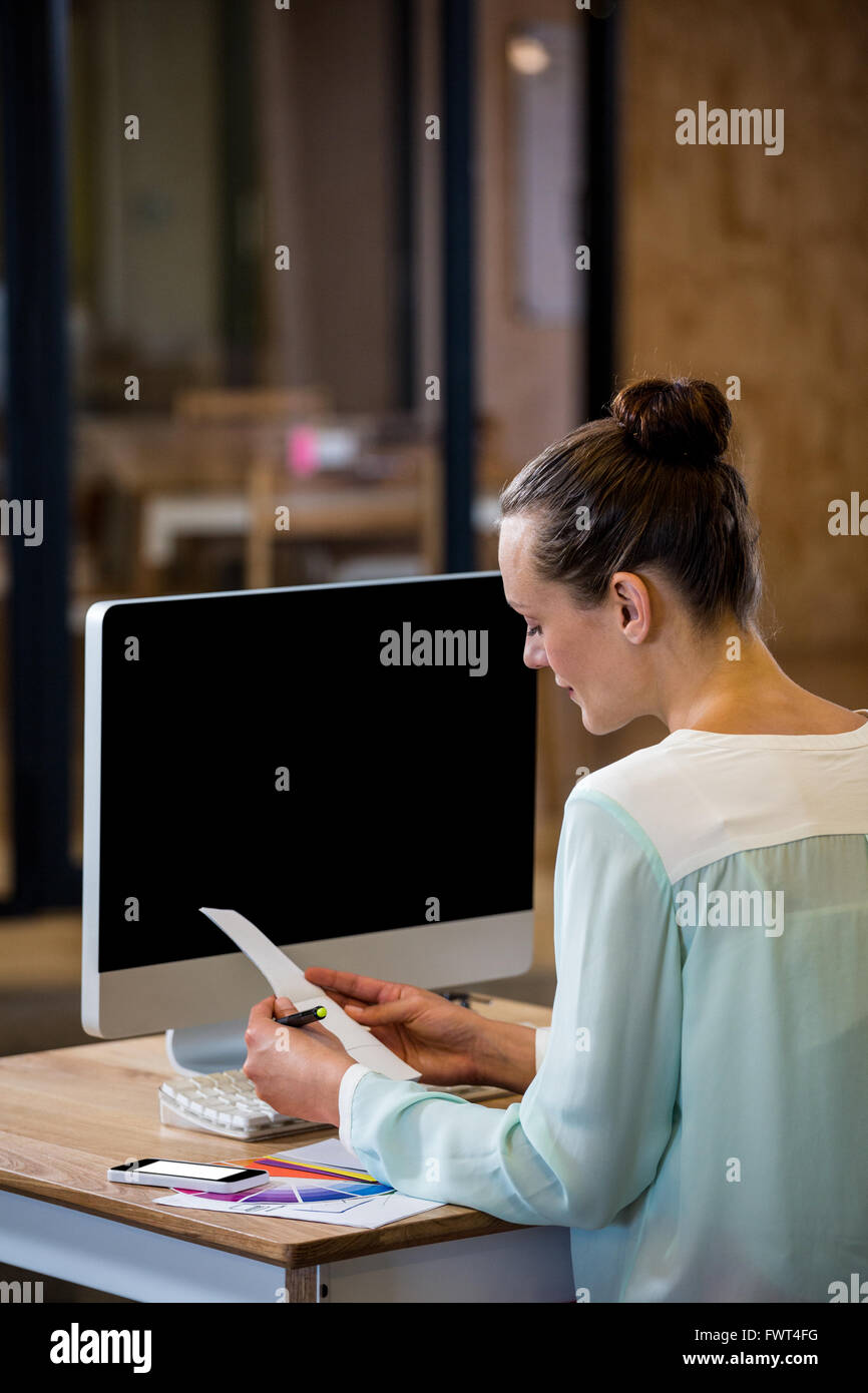 Woman reading a document in office Stock Photo - Alamy