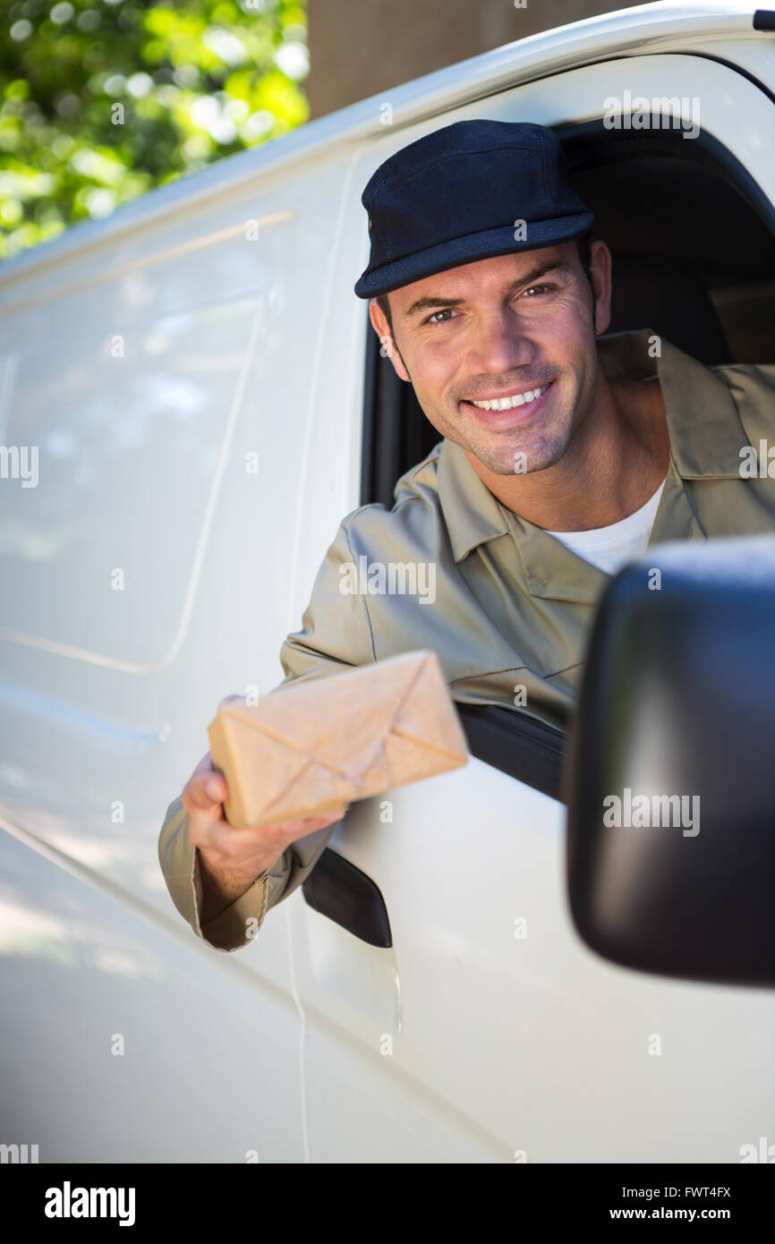 Smiling delivery man sitting in his van Stock Photo - Alamy