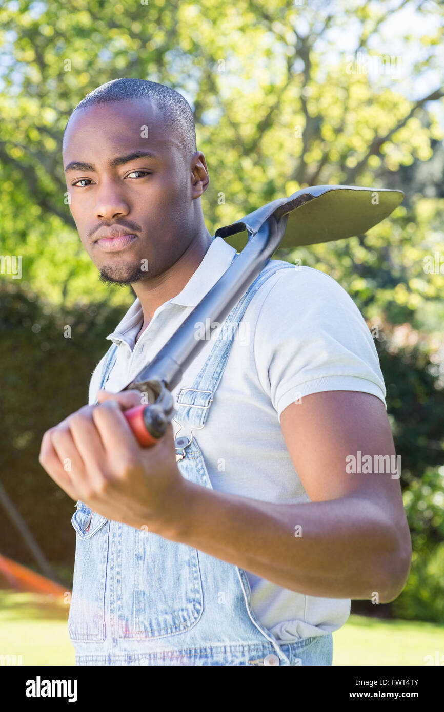 Young man posing with a shovel Stock Photo - Alamy