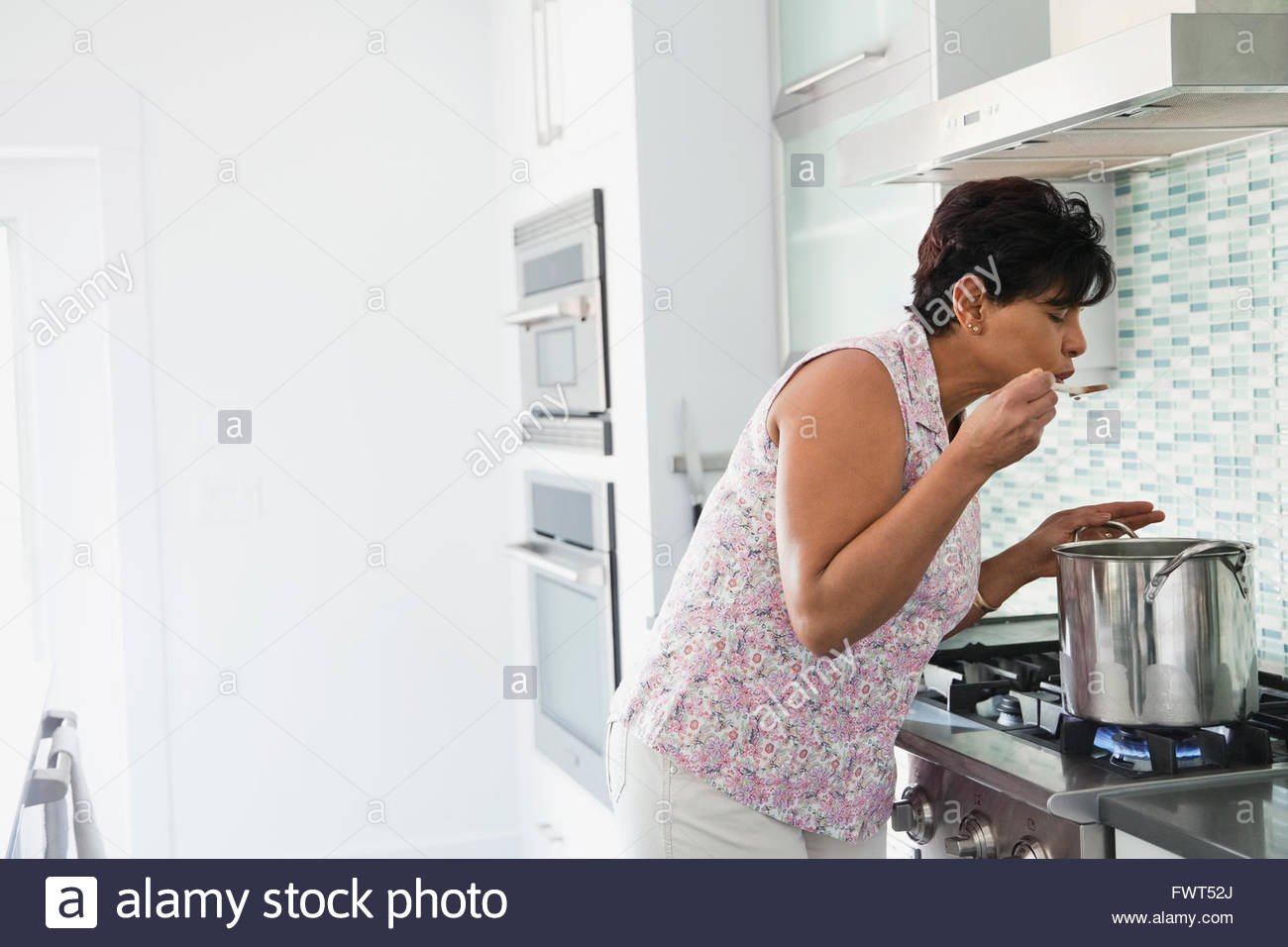 Woman tasting food hi-res stock photography and images - Alamy
