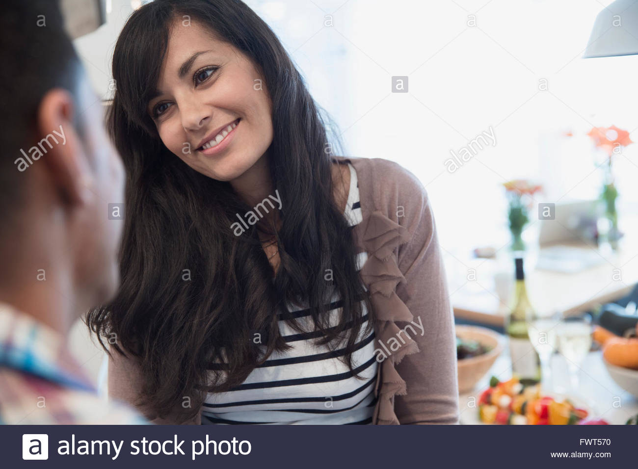 Happy mid adult woman looking lovingly at man in kitchen Stock Photo ...