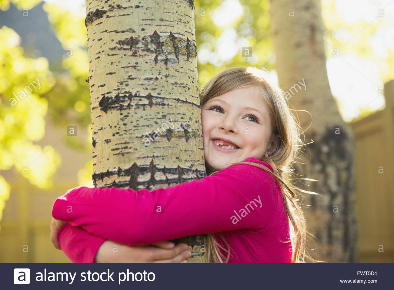 Girl hugging tree hi-res stock photography and images - Alamy