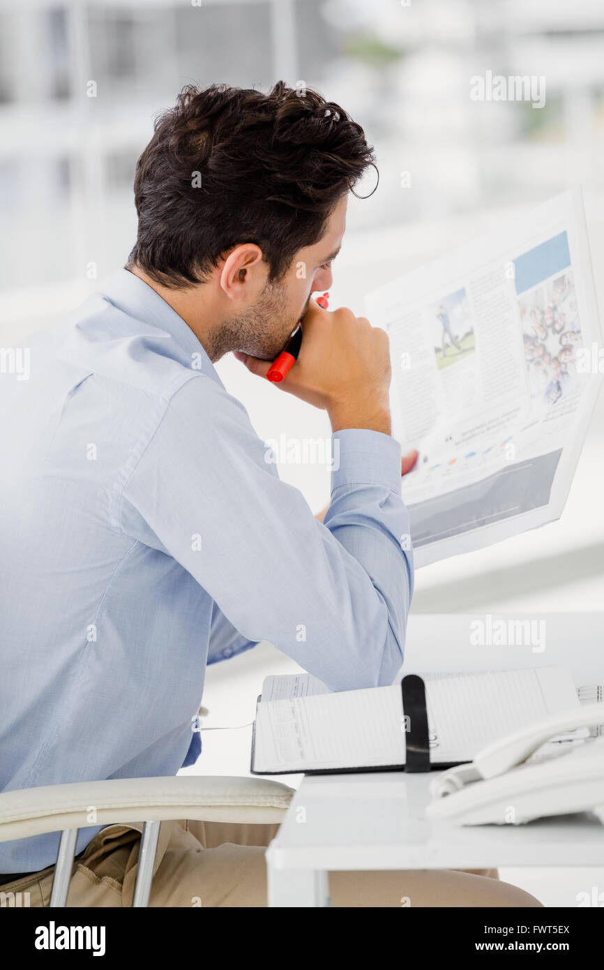 Businessman reading document at his desk Stock Photo - Alamy