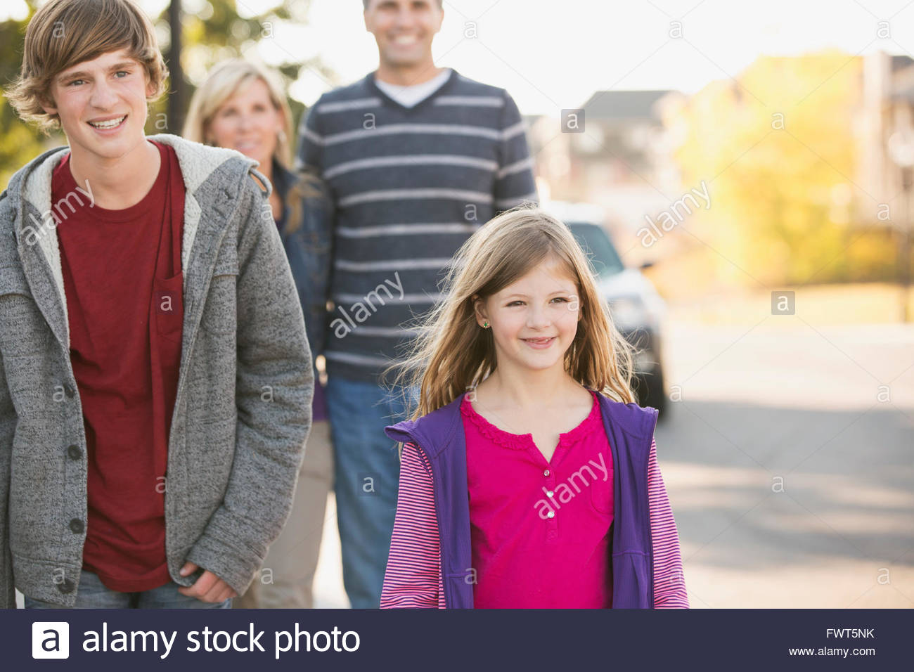 Happy family walking together Stock Photo - Alamy