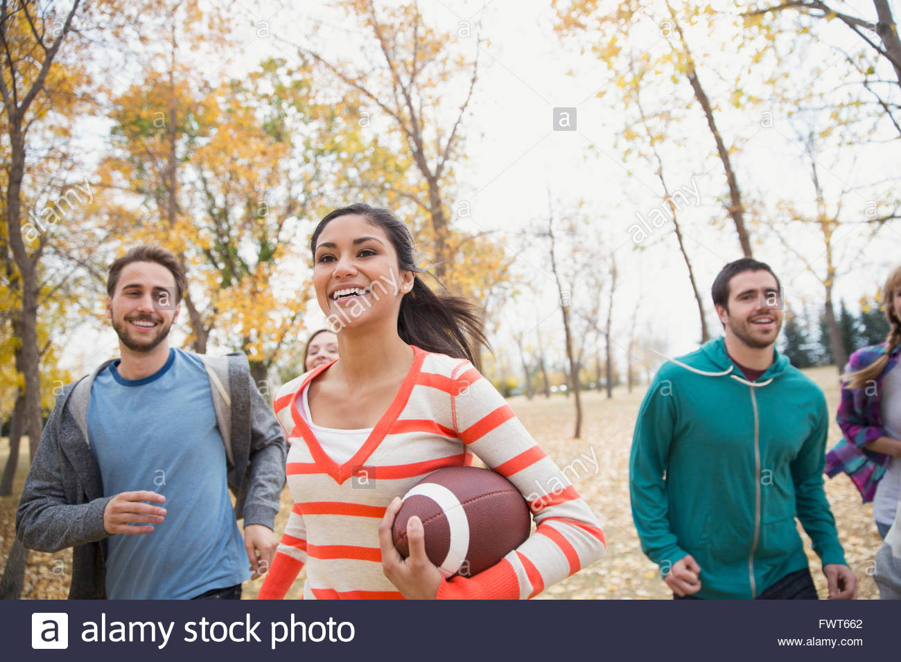 Adult friends playing football park hi-res stock photography and images ...