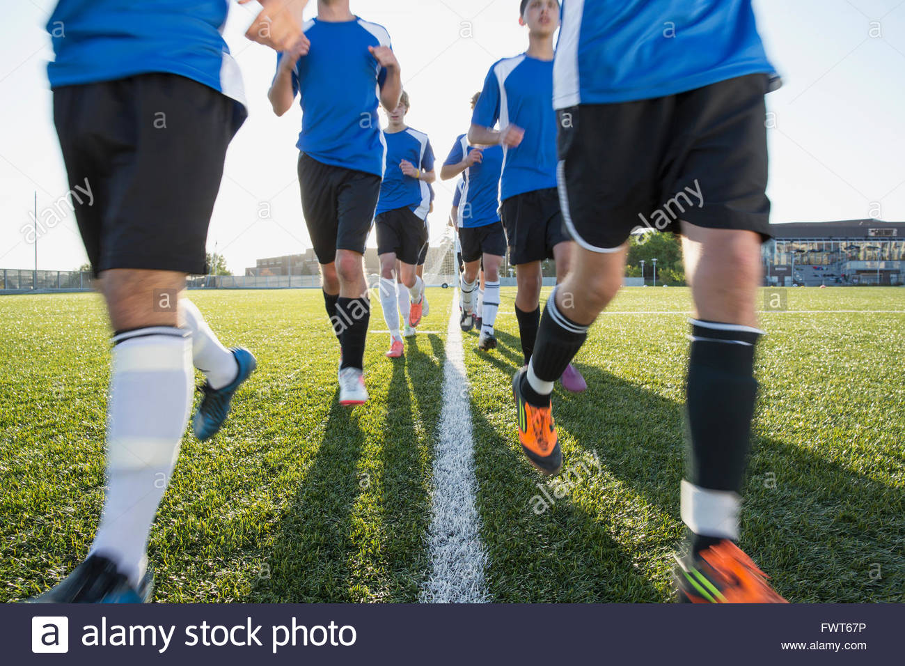 Soccer team running on field Stock Photo - Alamy
