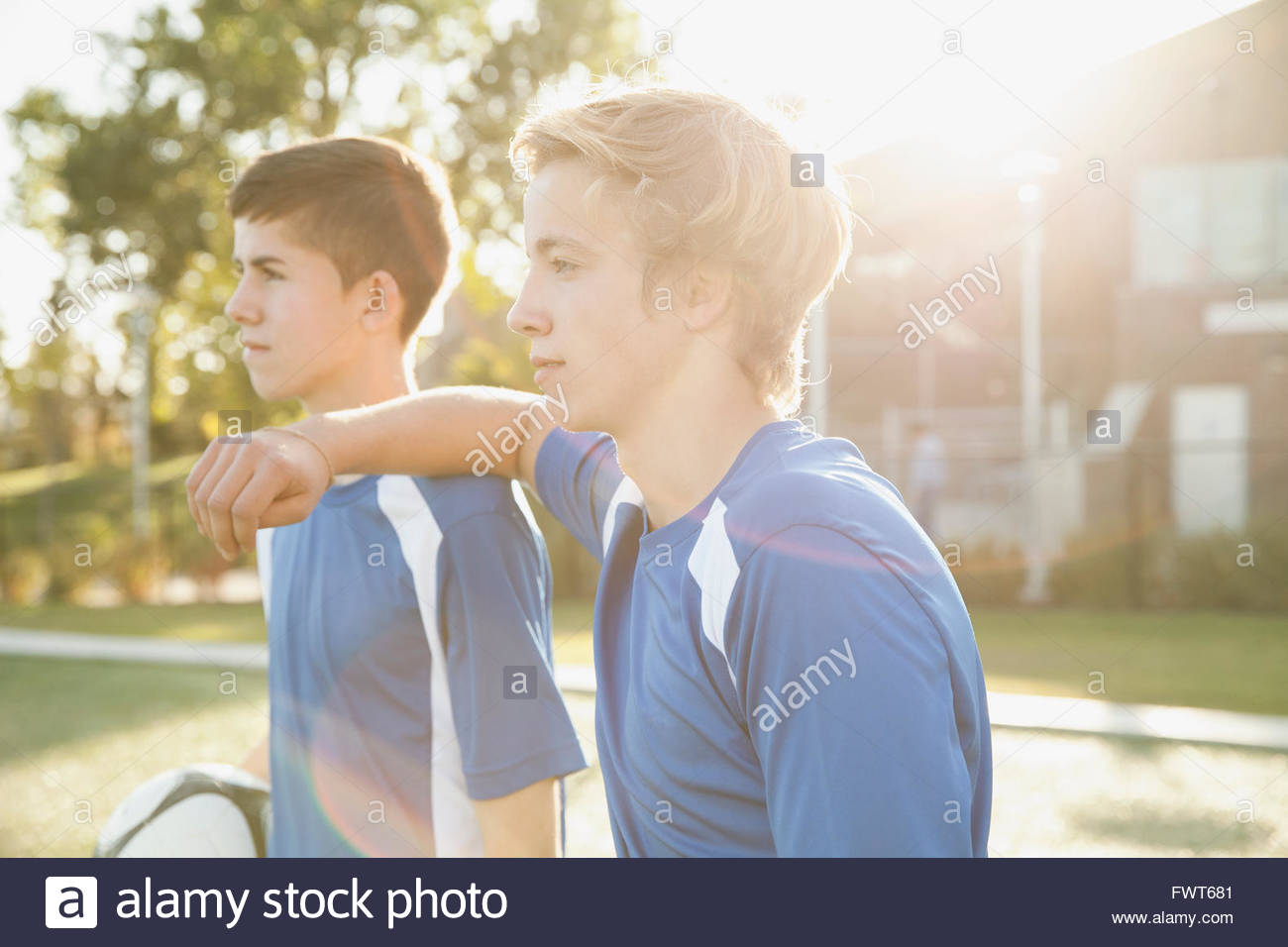 Soccer player with arm resting on teammate Stock Photo - Alamy