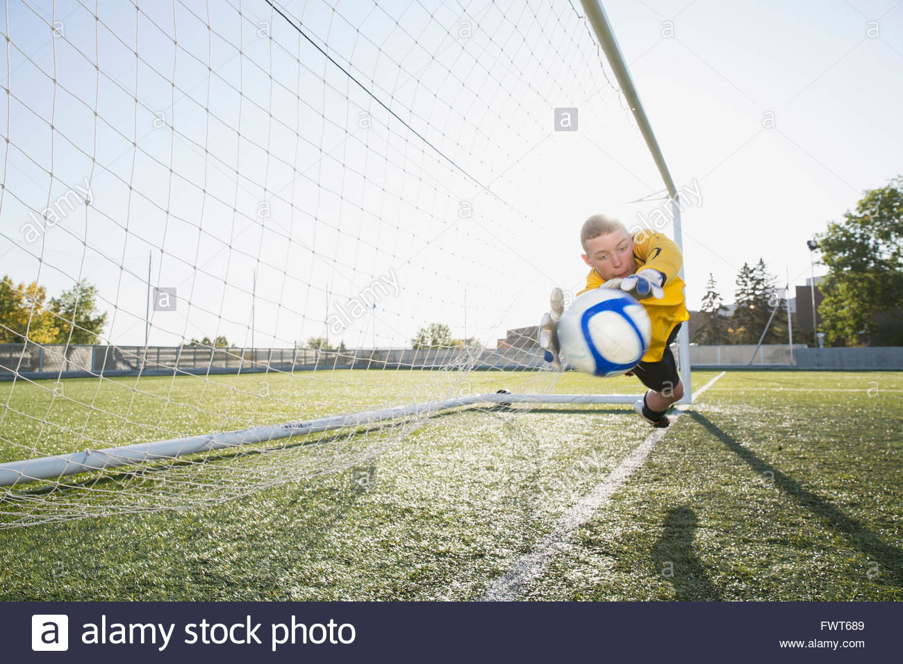 Soccer player stopping soccer ball hi-res stock photography and images ...